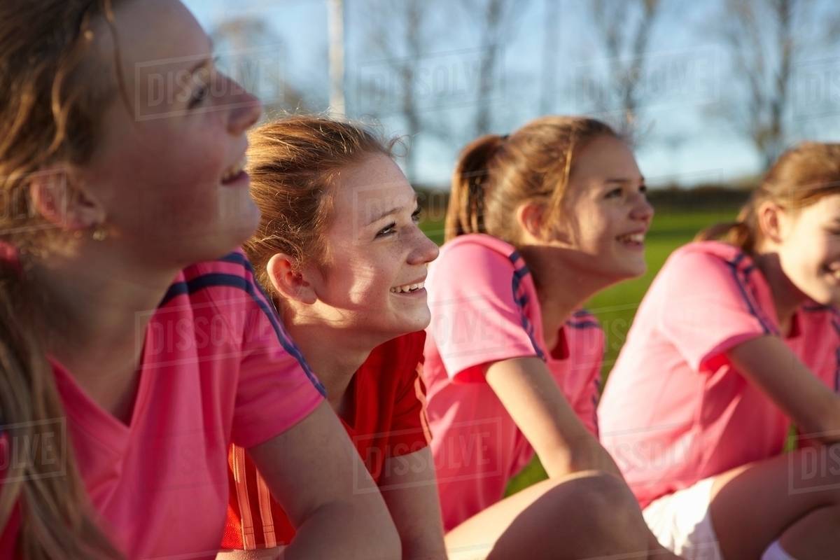 Football team smiling together in field - Stock Photo - Dissolve