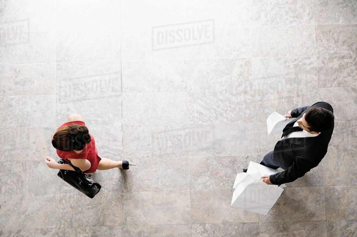 Overhead view of business people walking - Stock Photo - Dissolve