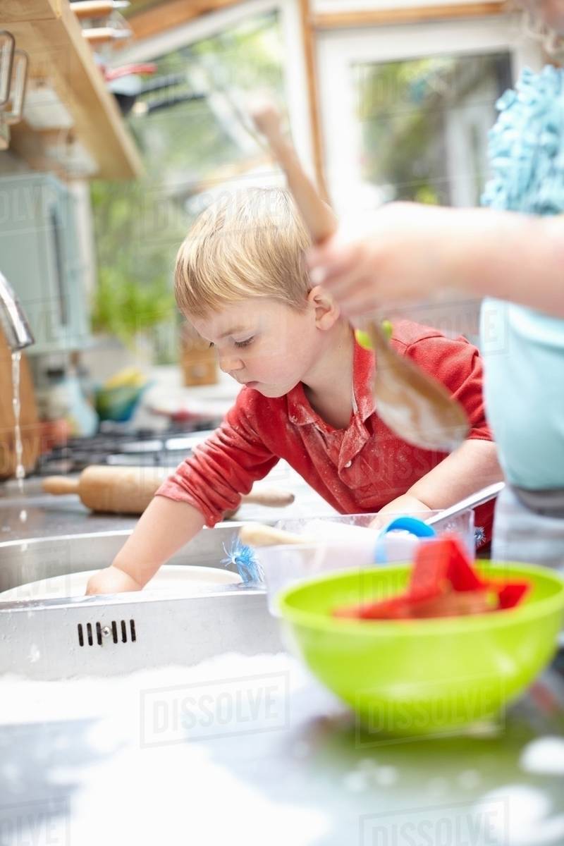 Children washing dishes together - Royalty-free Stock Photo | Dissolve