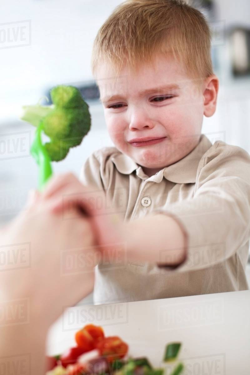 Crying boy refusing broccoli in kitchen - Royalty-free Stock Photo ...