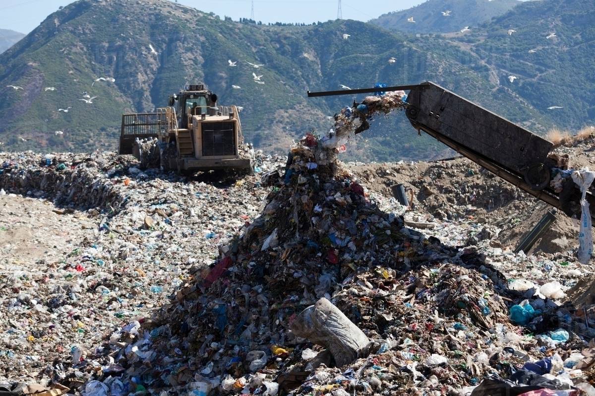 Machinery dumping waste in landfill - Stock Photo - Dissolve