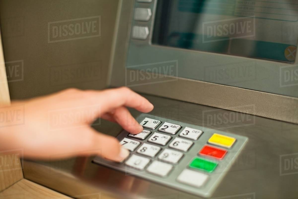 Woman using keypad on ATM - Royalty-free Stock Photo | Dissolve