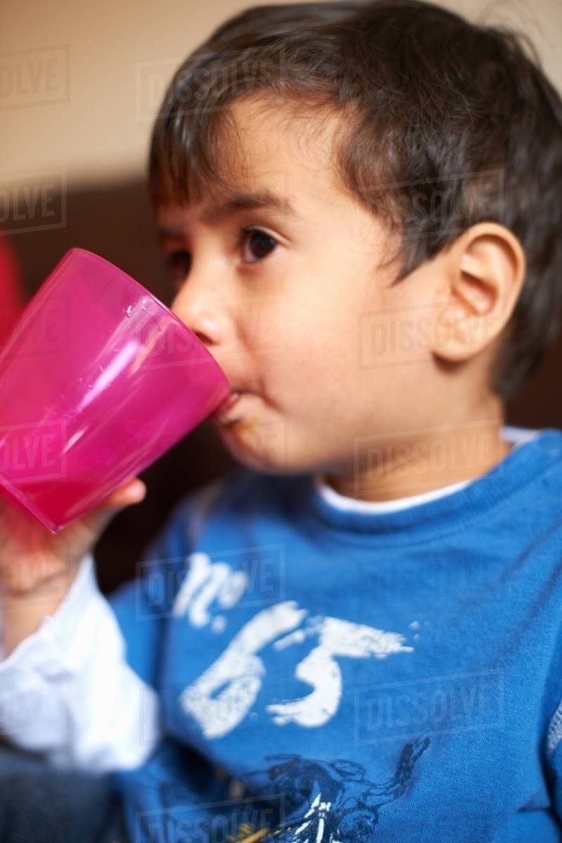 Boy drinking from plastic cup - Royalty-free Stock Photo | Dissolve