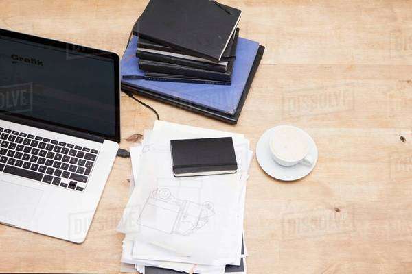 Laptop with books and coffee cup - Royalty-free Stock Photo | Dissolve