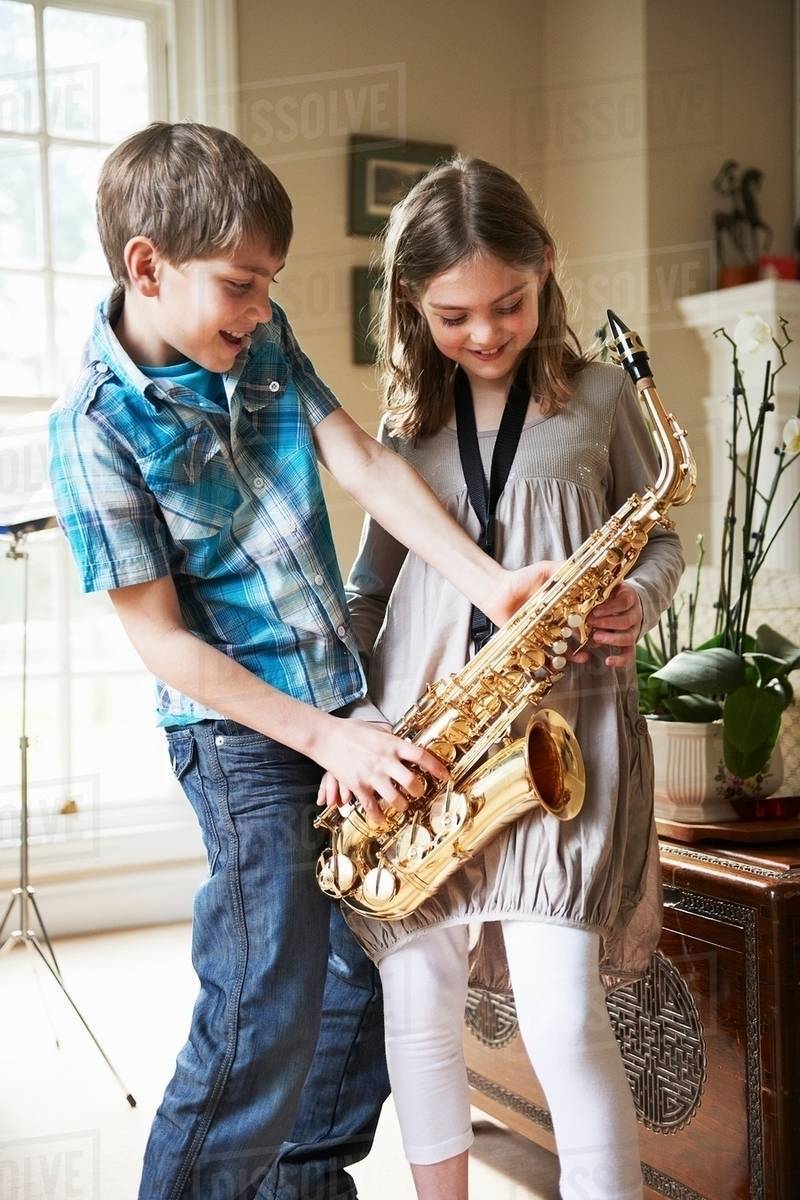 Children playing with saxophone - Royalty-free Stock Photo | Dissolve