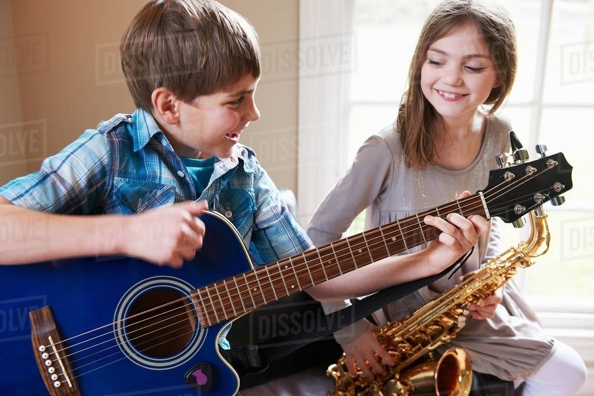 Children playing music together - Stock Photo - Dissolve