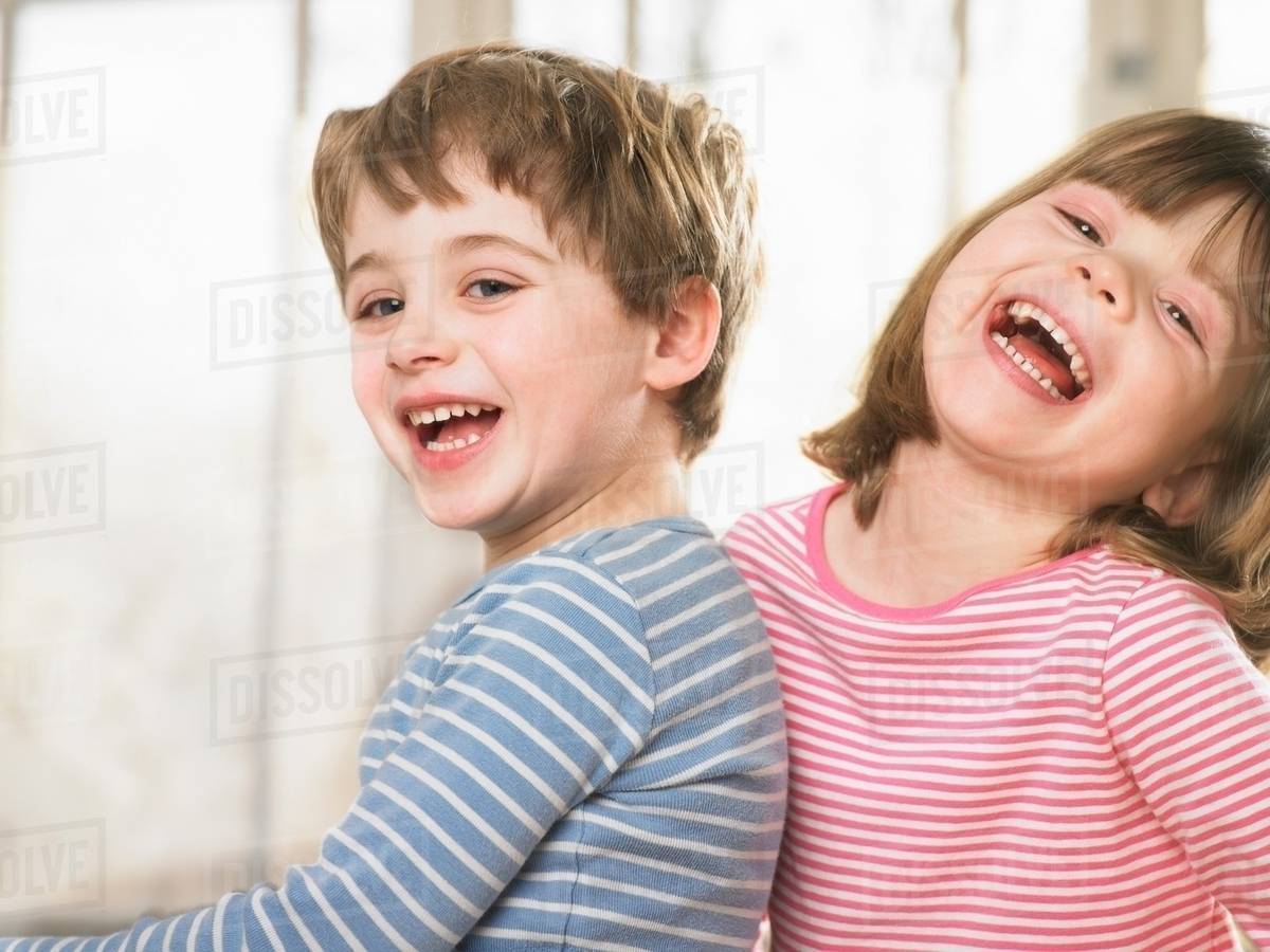 Children smiling together indoors - Royalty-free Stock Photo | Dissolve