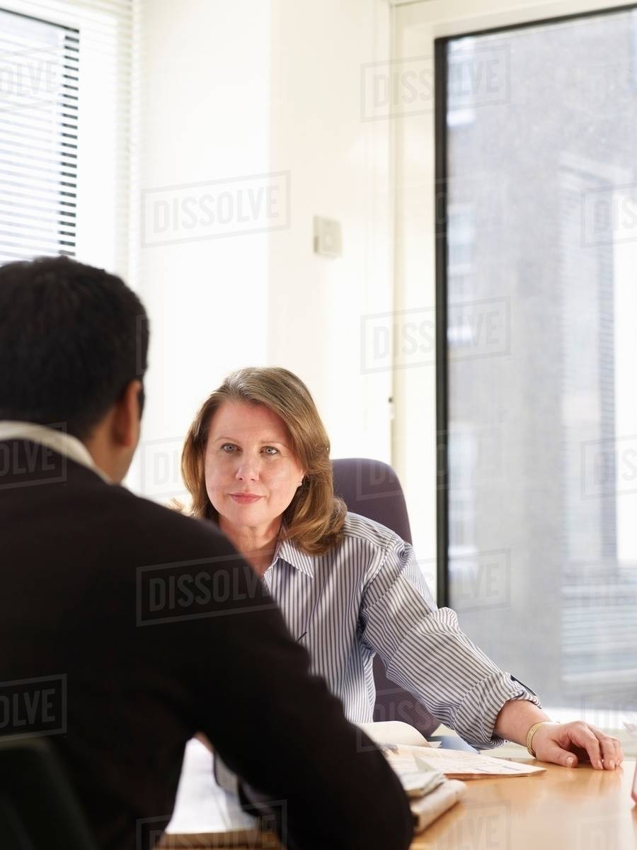 Business people talking at desk - Royalty-free Stock Photo | Dissolve