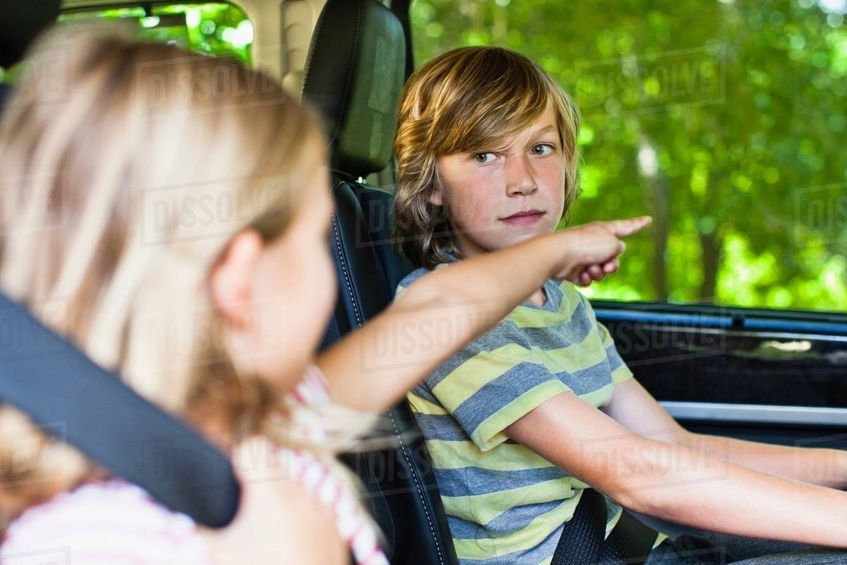 Children sitting in backseat of car - Royalty-free Stock Photo | Dissolve