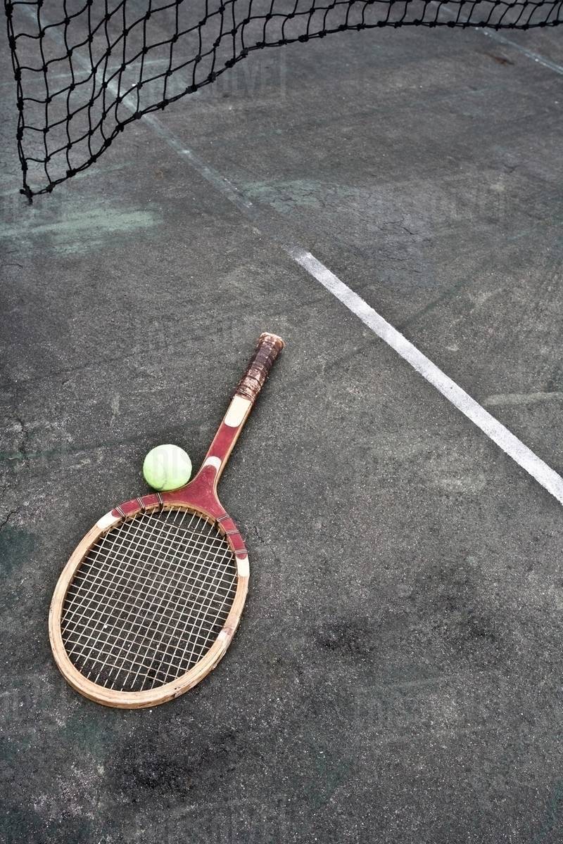Tennis racket and ball on court - Royalty-free Stock Photo | Dissolve