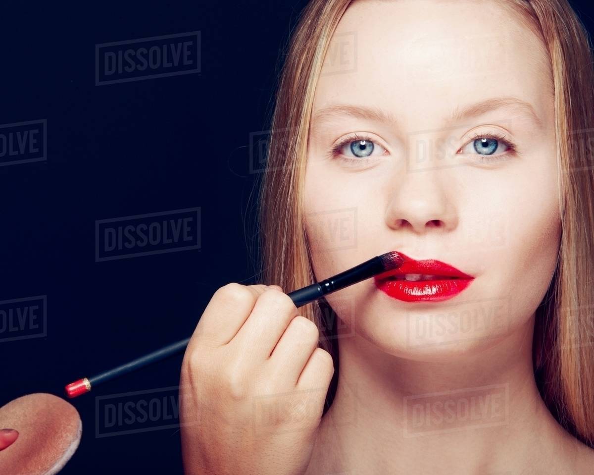 Woman having makeup applied - Stock Photo - Dissolve