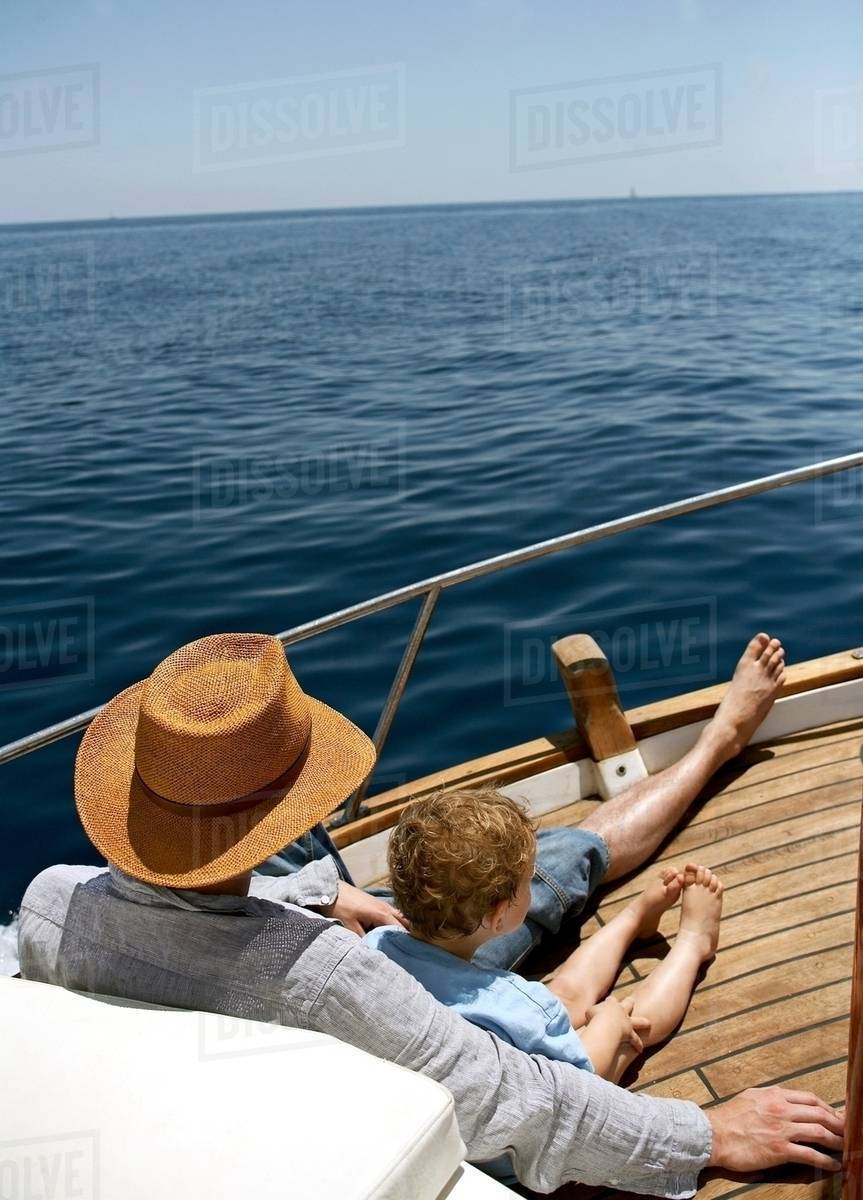 Father and son relaxing on boat - Royalty-free Stock Photo | Dissolve