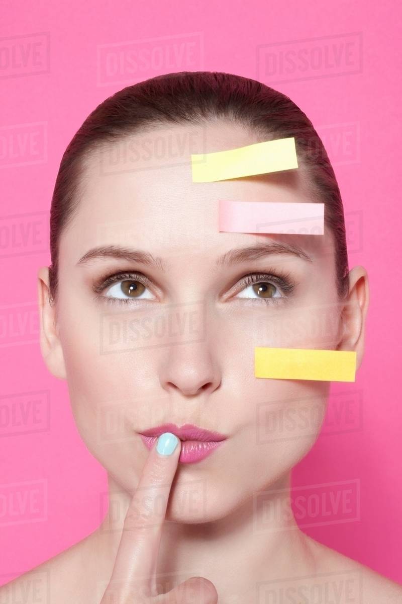 Woman with sticky notes on face - Royalty-free Stock Photo | Dissolve