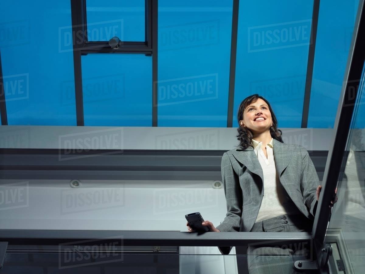 Smart lady in corporate environment with mobile phone - Stock Photo ...