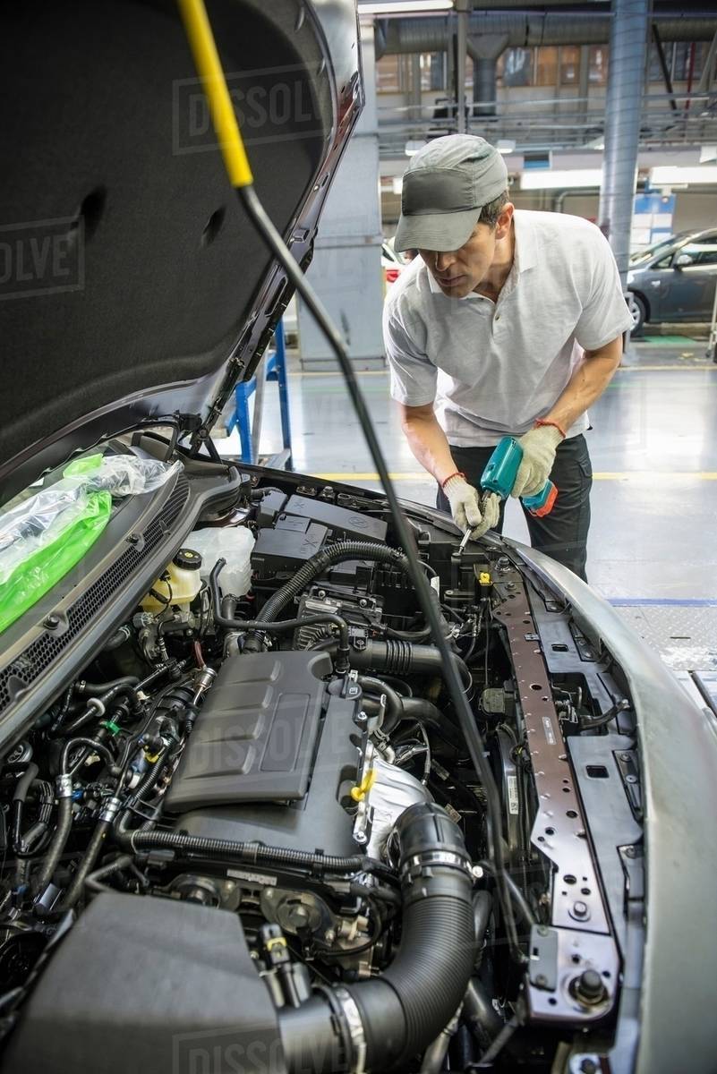 Car assembly worker in car factory - Stock Photo - Dissolve