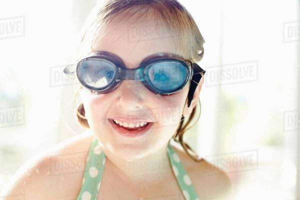 Smiling girl wearing goggles - Royalty-free Stock Photo | Dissolve
