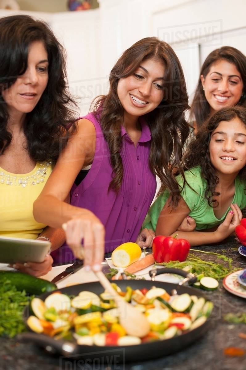Women cooking together in kitchen - Royalty-free Stock Photo | Dissolve