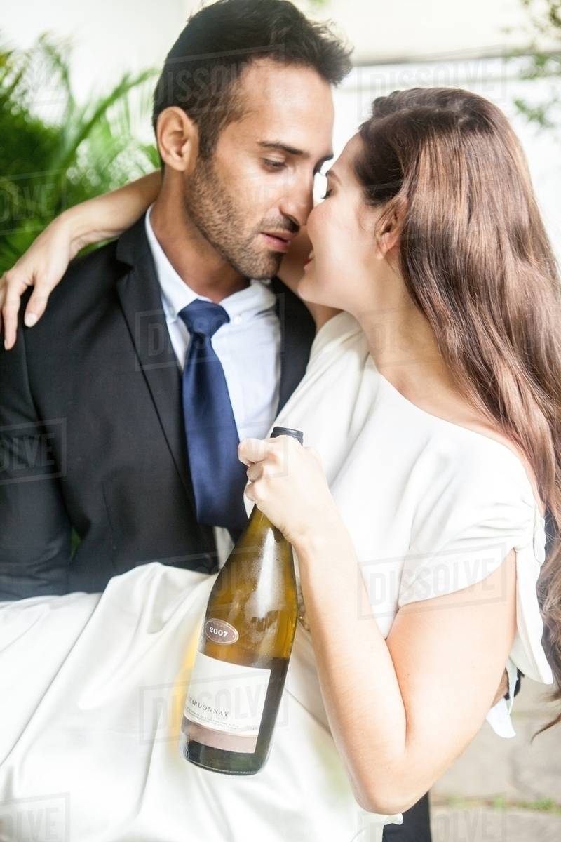 Couple hugging, woman holding wine bottle - Royalty-free Stock Photo ...