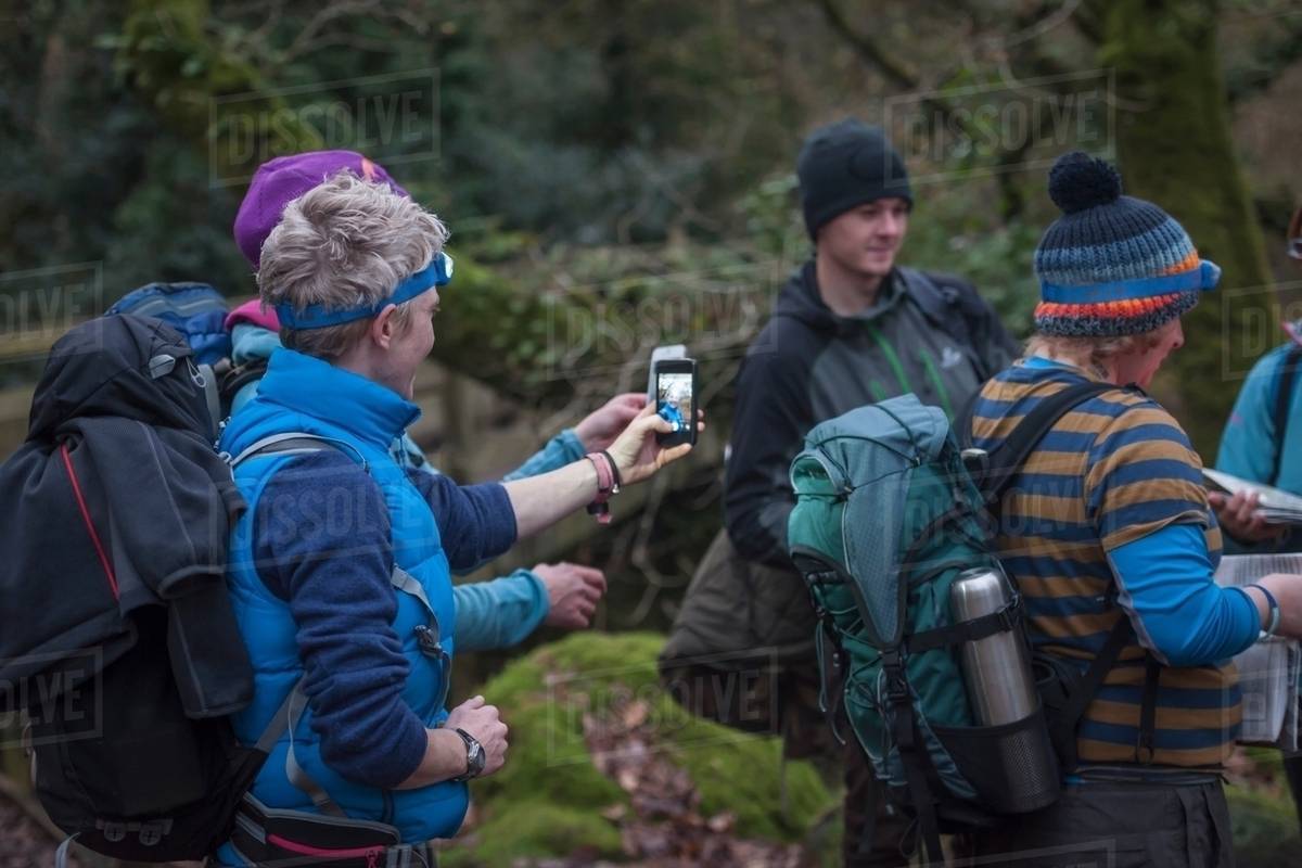 Group of people preparing to go orienteering - Stock Photo - Dissolve