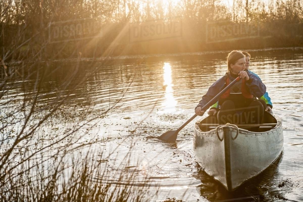 Two women canoeing - Stock Photo - Dissolve