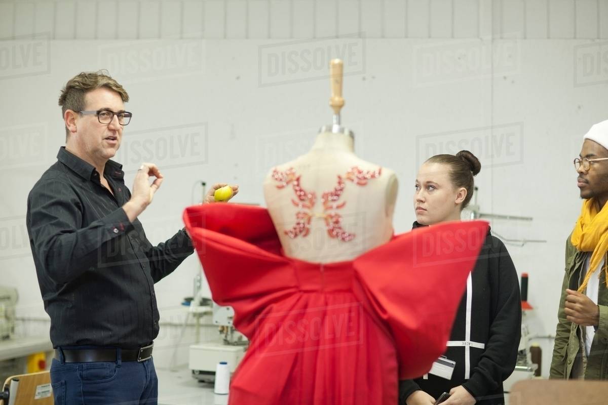 Fashion design teacher assessing students work - Royalty-free Stock ...