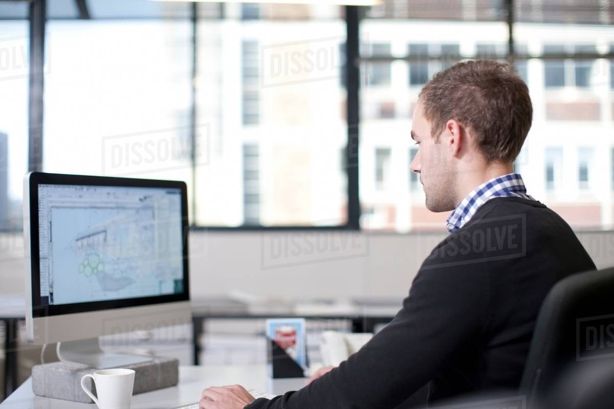 Man using computer in office - Royalty-free Stock Photo | Dissolve