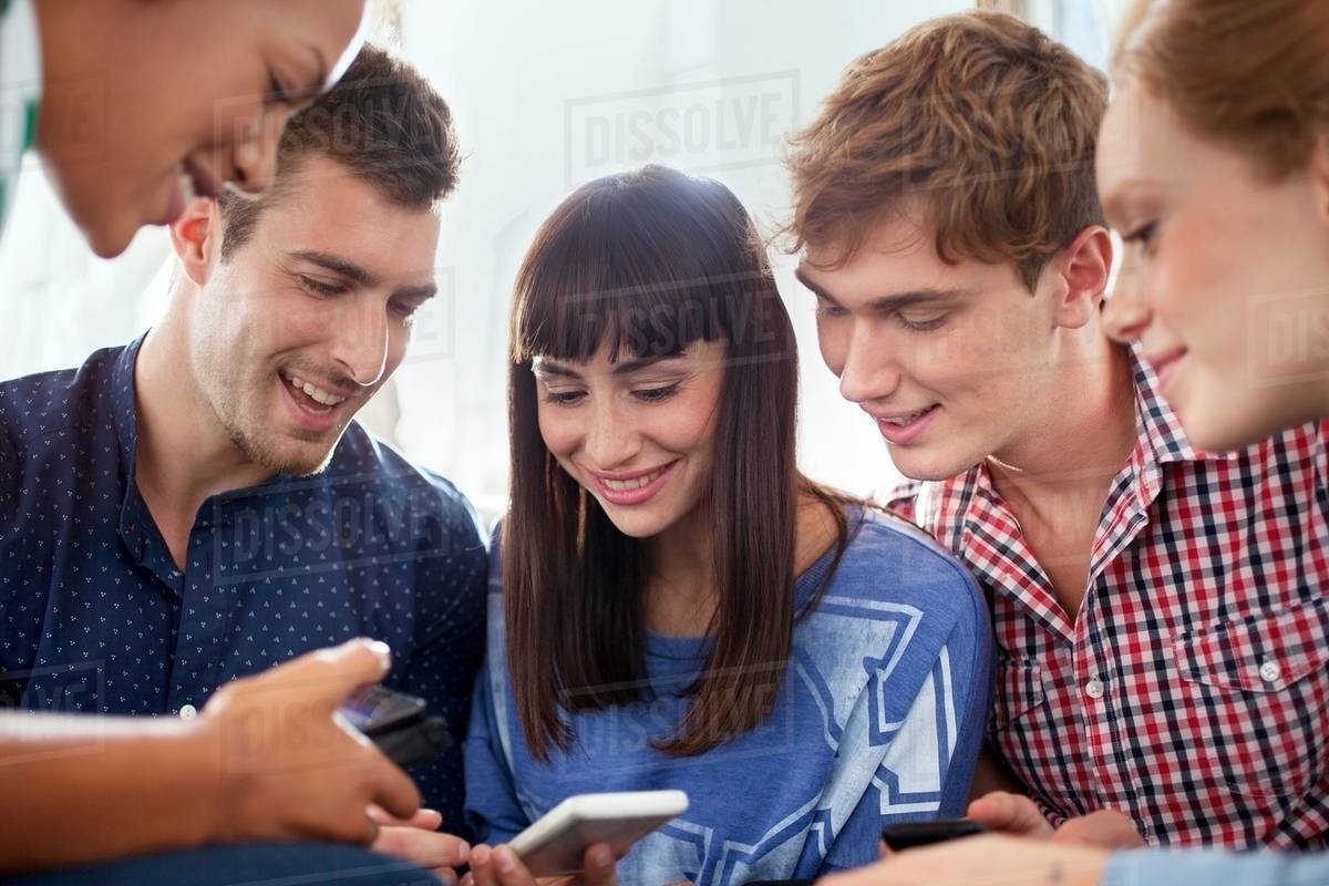 Group of five friends using smartphones - Royalty-free Stock Photo ...
