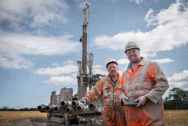 Portrait of drilling rig workers in hard hats and workwear - Stock ...