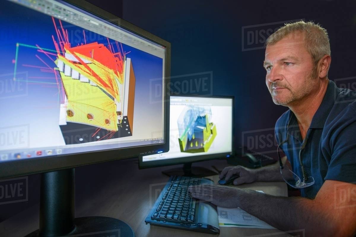 Engineer looking at computer monitor with Computer Aided Design ...