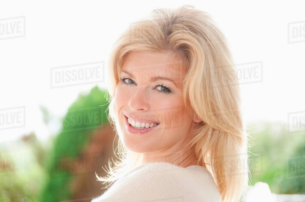 Portrait of mid adult woman smiling - Royalty-free Stock Photo | Dissolve