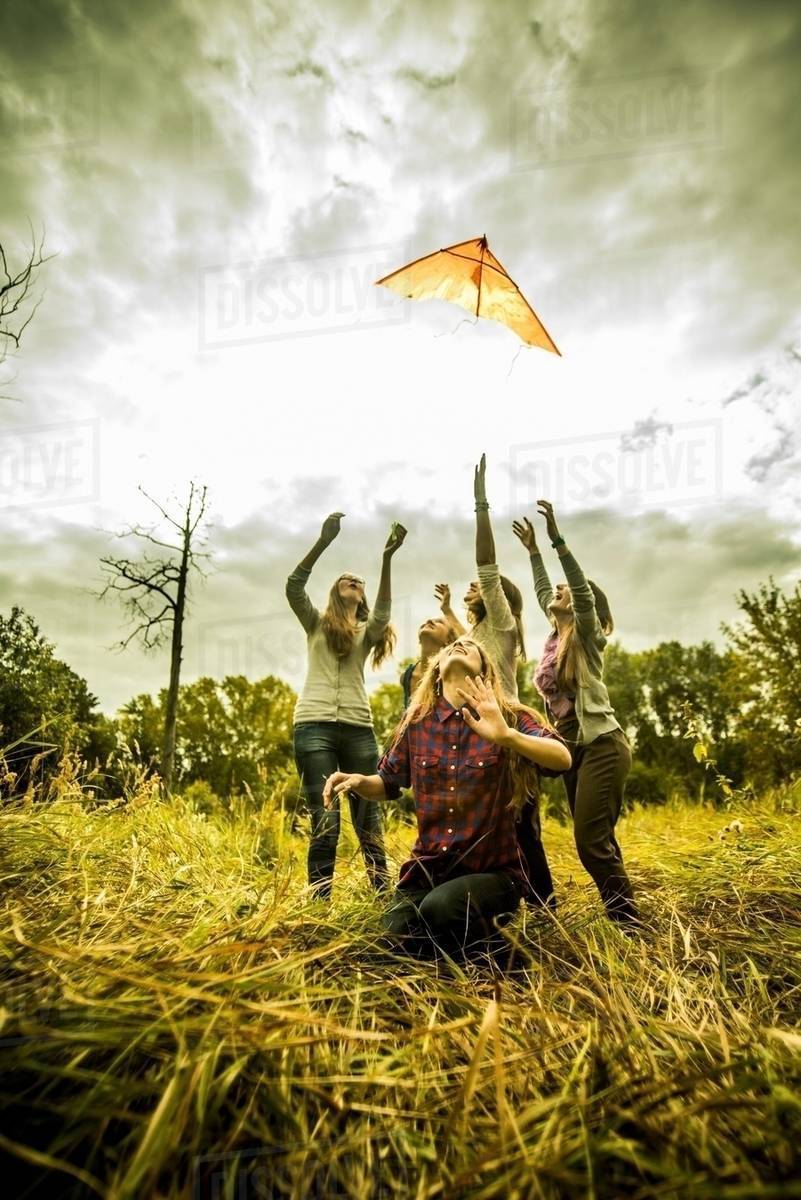 Five young women flying kite in scrubland - Royalty-free Stock Photo ...