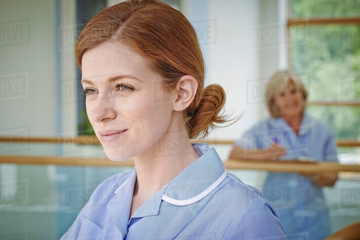Two female nurses on hospital atrium balcony - Royalty-free Stock Photo ...