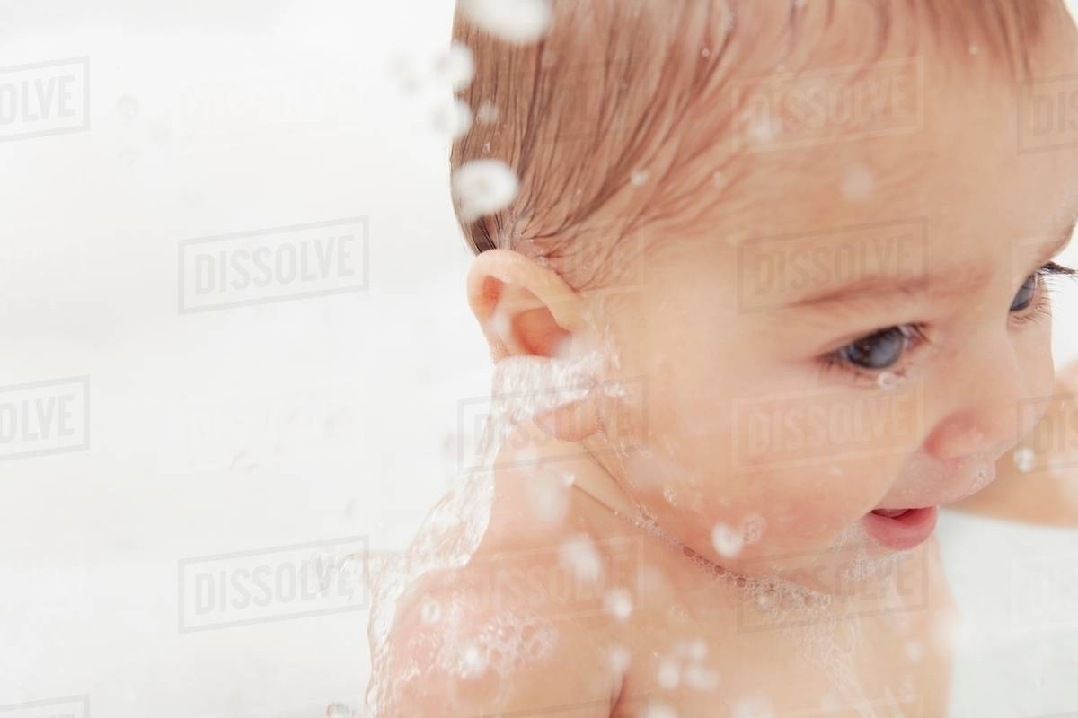 Baby splashing in bathtub - Royalty-free Stock Photo | Dissolve