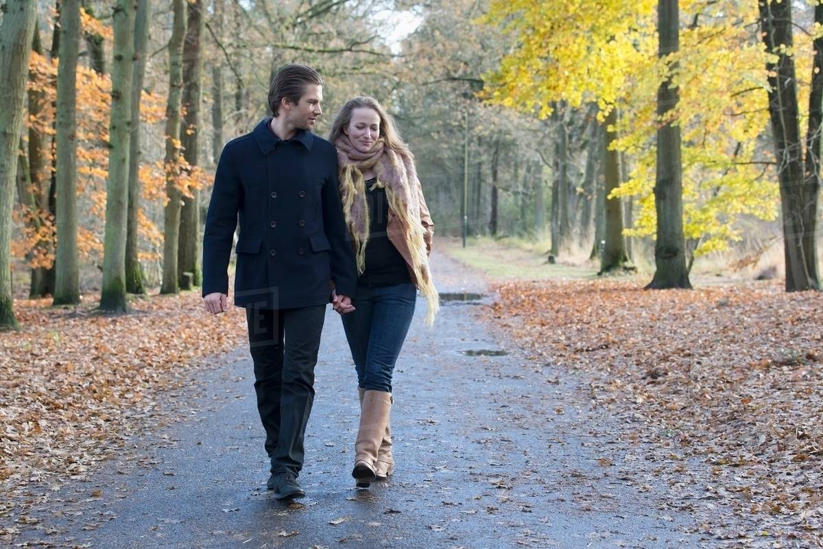 Couple walking through forest - Royalty-free Stock Photo | Dissolve