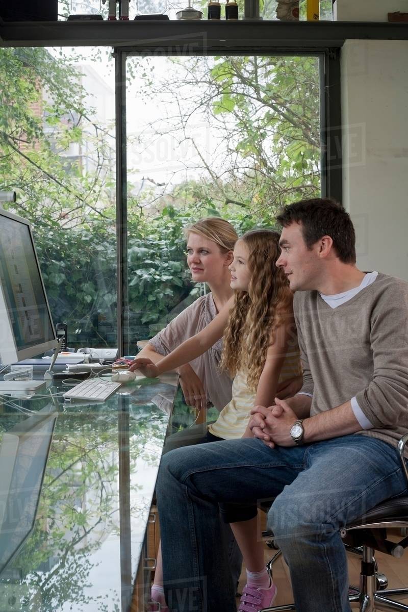 Girl and parents at home using computer - Royalty-free Stock Photo ...