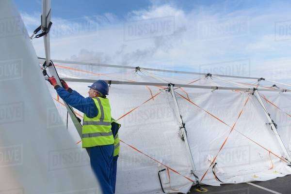 Emergency Response Team workers erecting tent control centre - Stock ...