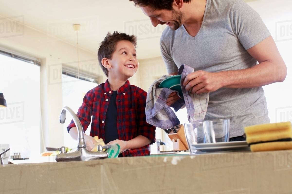 Father and son doing washing up - Stock Photo - Dissolve
