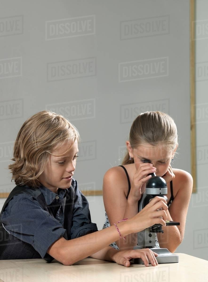 Two kids using microscope - Royalty-free Stock Photo | Dissolve