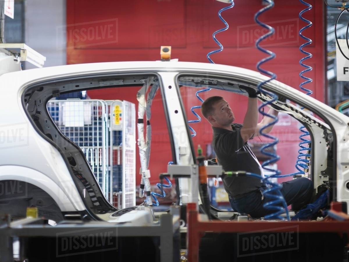 Worker Assembling Car On Production Line - Stock Photo - Dissolve