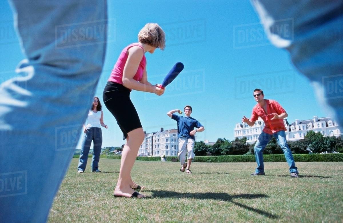 A group playing baseball in a park - Royalty-free Stock Photo | Dissolve
