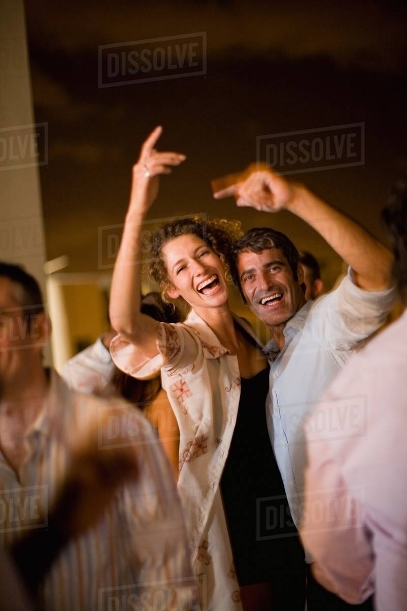 Couple dancing at party at night - Royalty-free Stock Photo | Dissolve