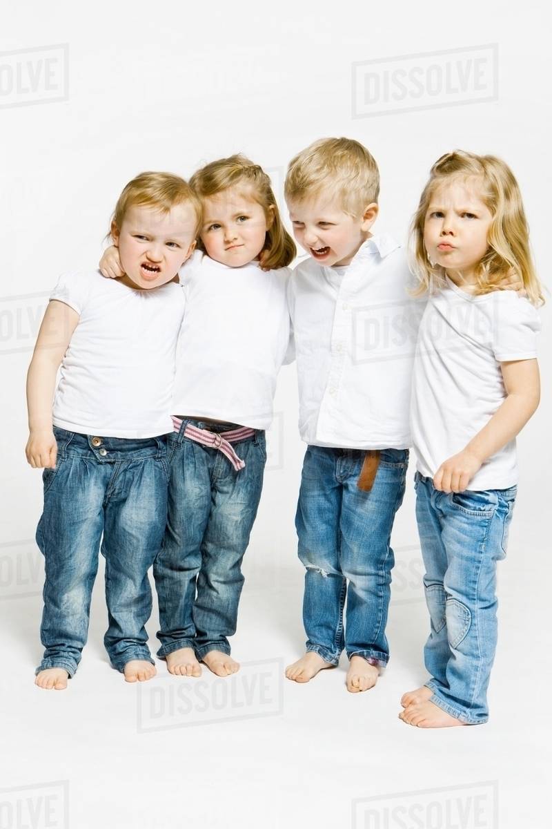 Four toddlers hugging - Stock Photo - Dissolve