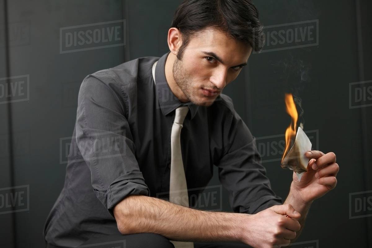 Businessman burning paper - Royalty-free Stock Photo | Dissolve