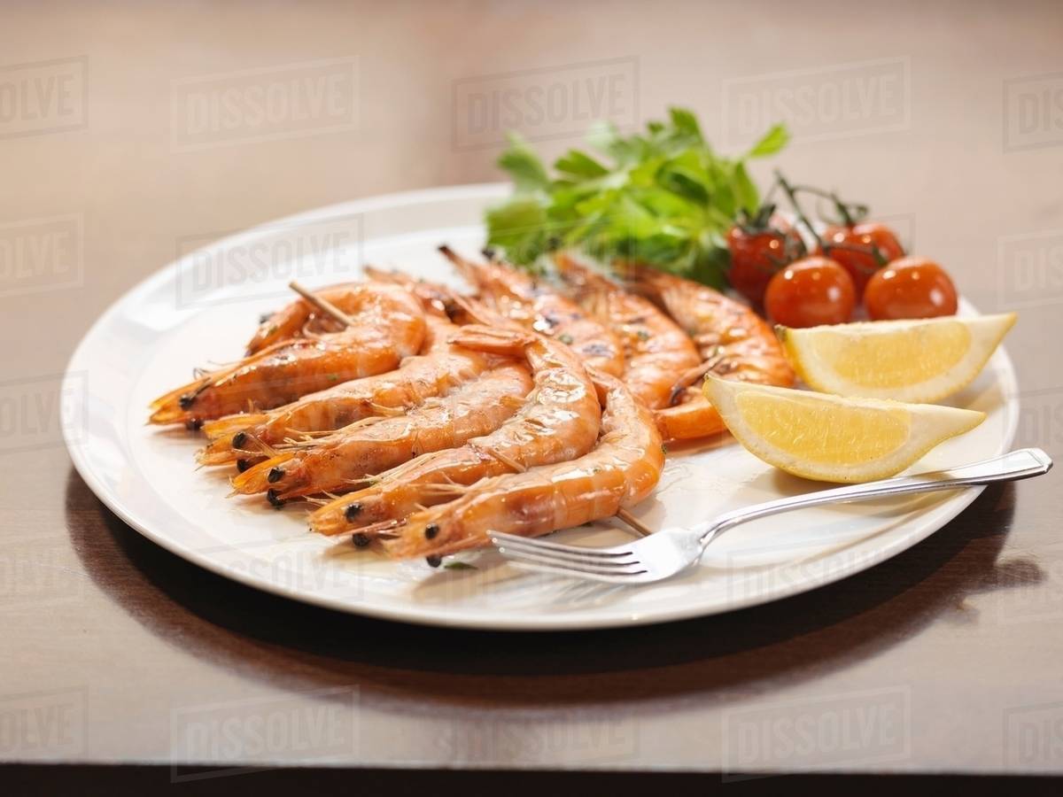 Plate of prawns at restaurant - Stock Photo - Dissolve