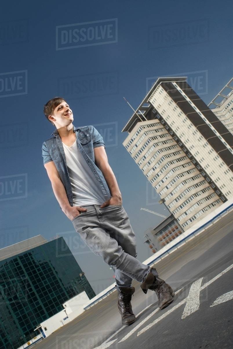 Man standing on urban rooftop - Stock Photo - Dissolve