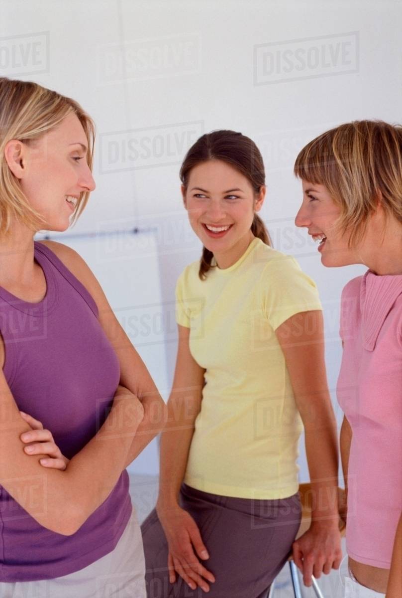 Smiling women talking in office - Royalty-free Stock Photo | Dissolve