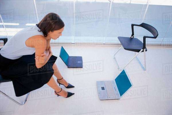 Businesswoman using laptop on floor - Royalty-free Stock Photo | Dissolve