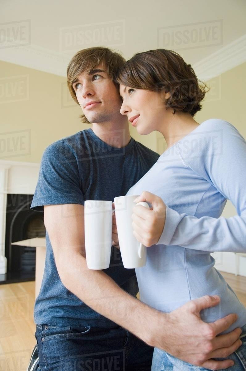 Couple hugging with coffee in new home - Royalty-free Stock Photo ...