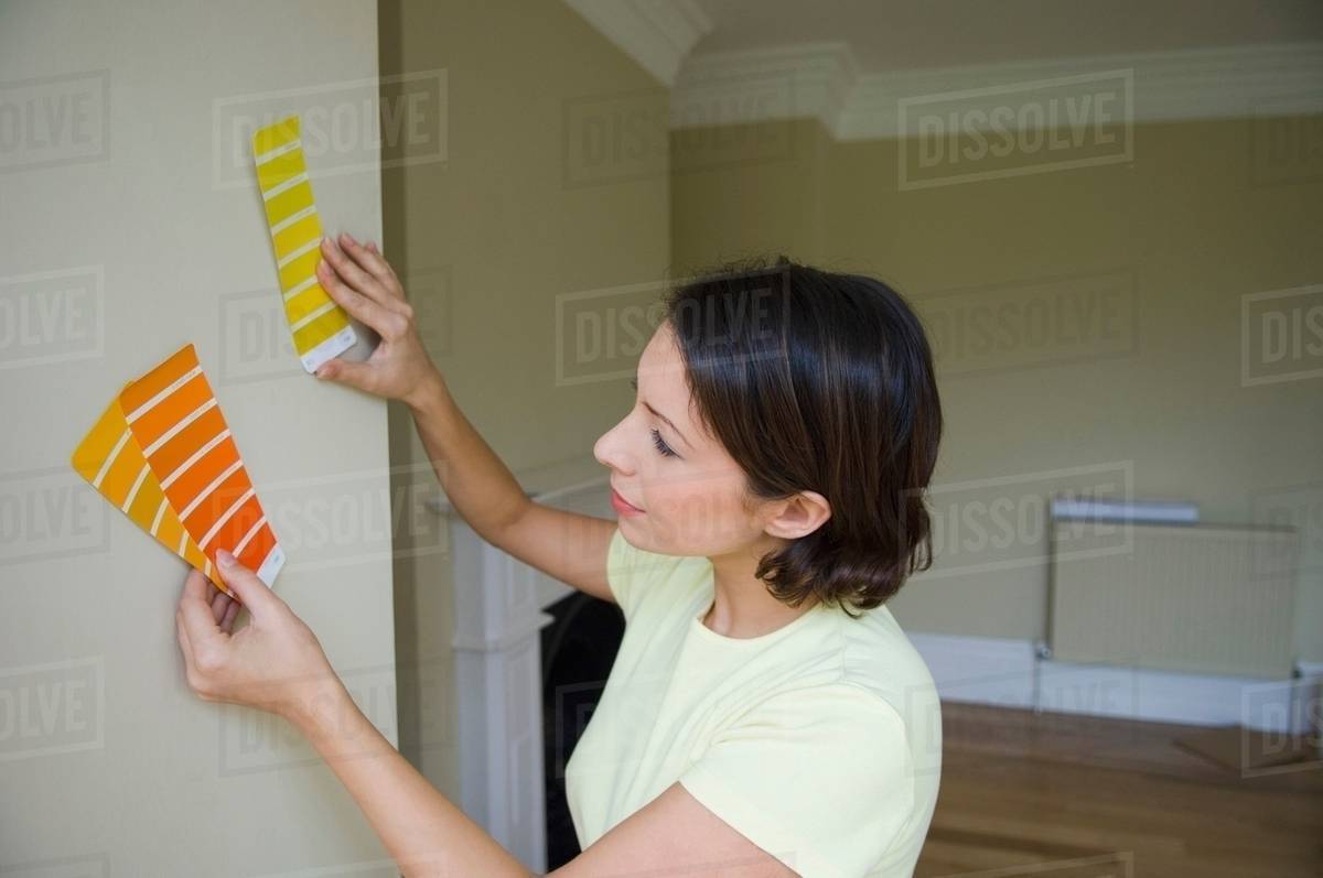 Woman choosing paint color in new home - Royalty-free Stock Photo ...