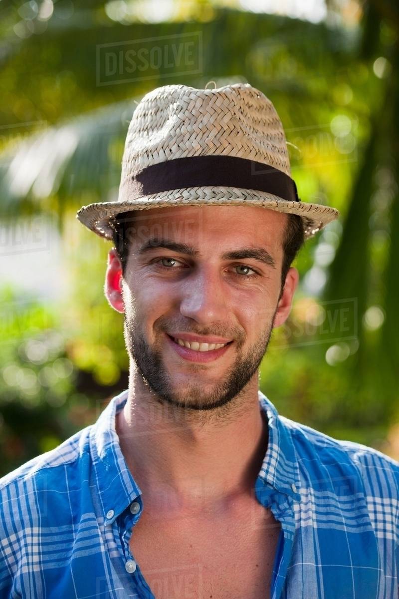Man wearing straw hat outdoors - Royalty-free Stock Photo | Dissolve